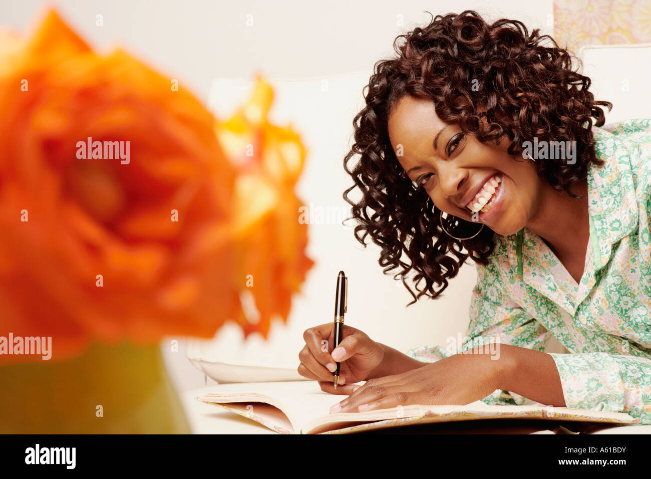 African woman writing in book Stock Photo - Alamy