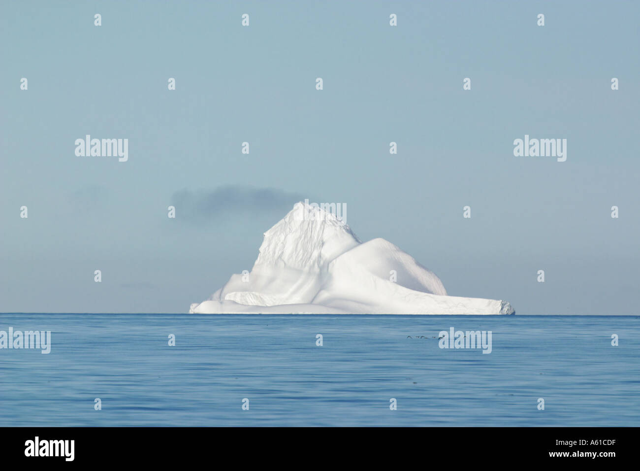 Iceberg forming stratus cloud at its peak Thule Greenland Stock Photo ...