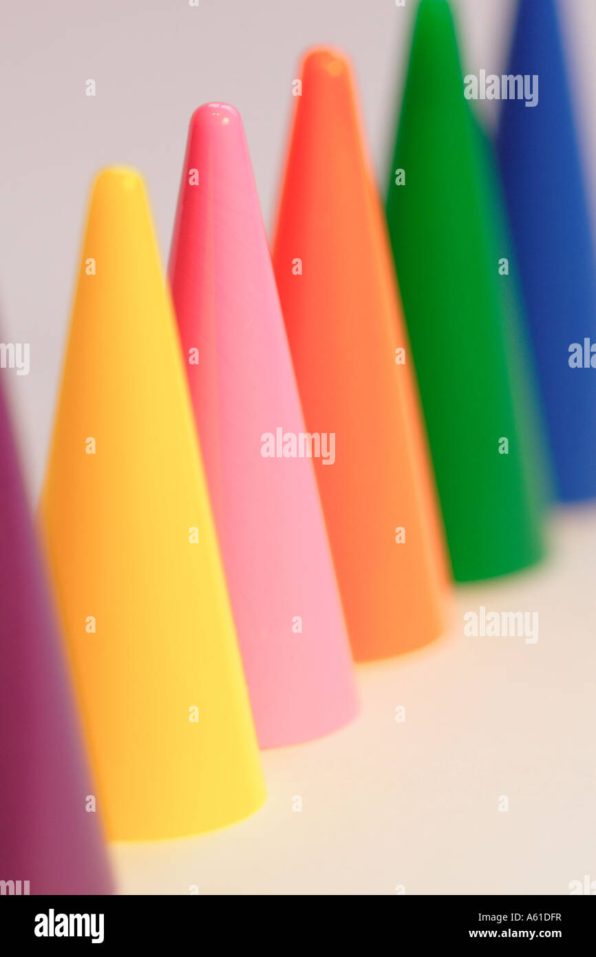 Line of bright colourful cone shape counters Stock Photo - Alamy