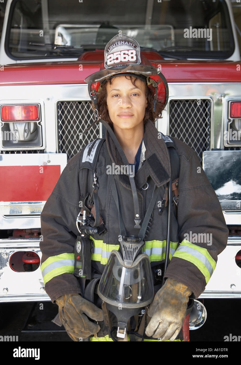 African female firefighter in front of fire truck Stock Photo - Alamy