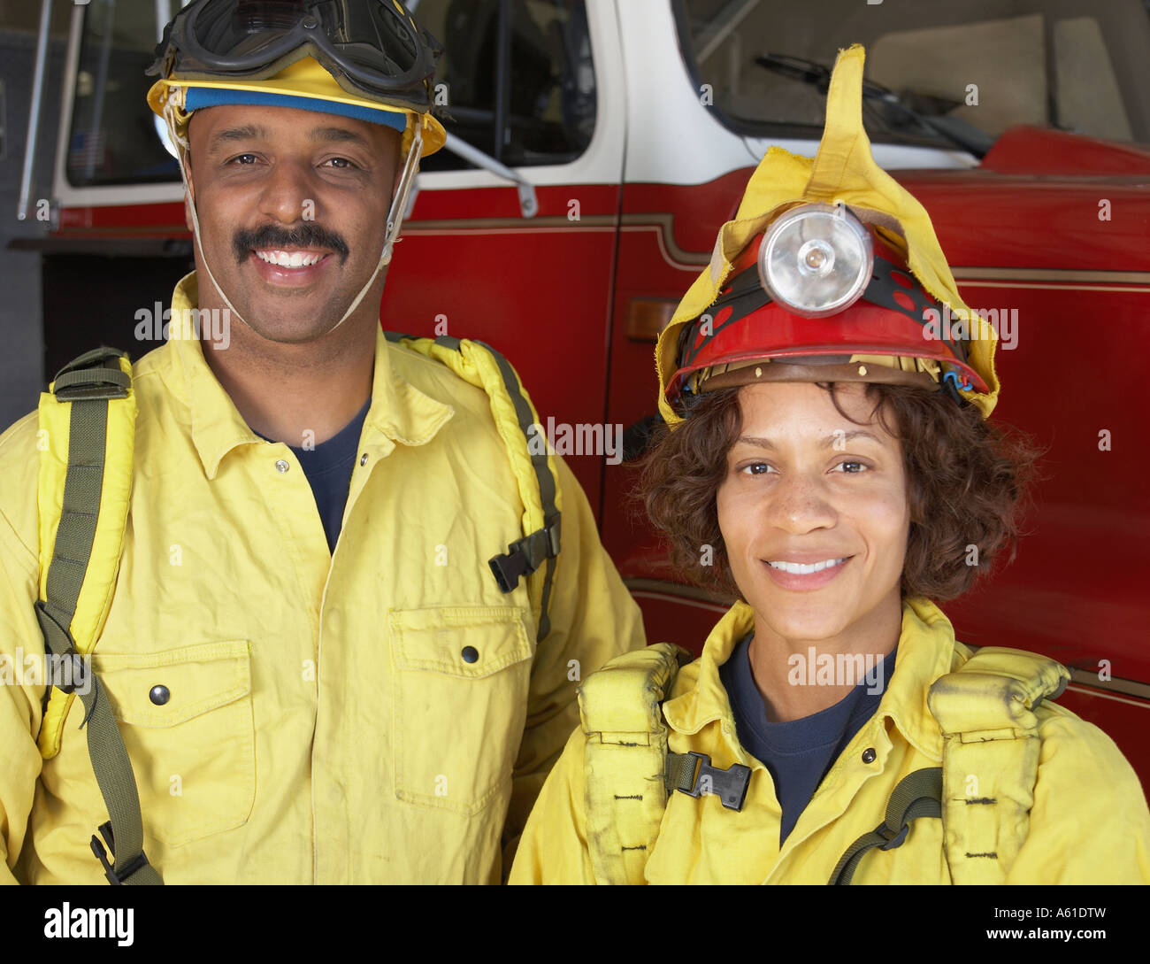 Two African firefighters next to fire truck Stock Photo - Alamy
