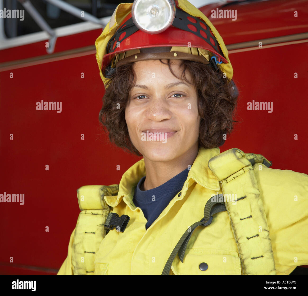 African female firefighter leaning against fire truck Stock Photo - Alamy