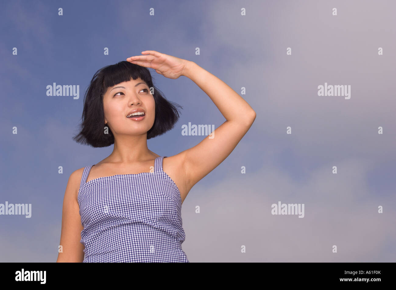 Asian woman shading eyes with hand Stock Photo - Alamy