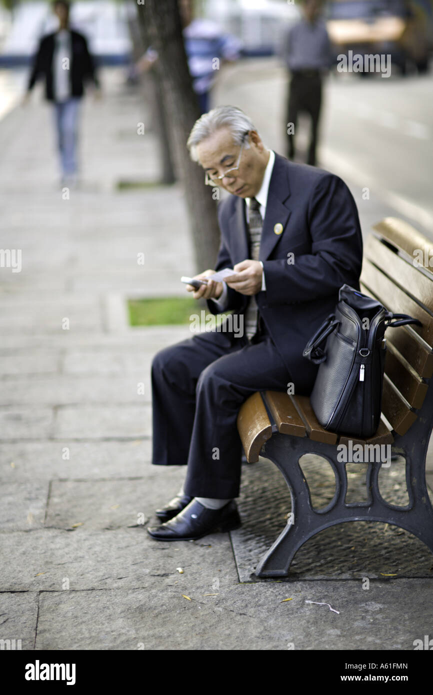 CHINA HANGZHOU Chinese businessman using his cell phone Stock Photo - Alamy