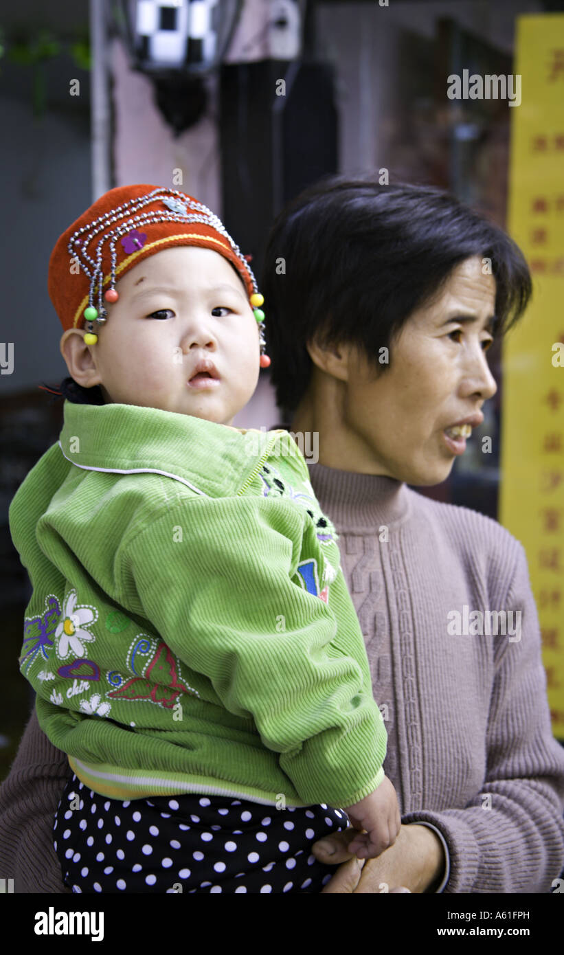 CHINA BEIJING Chinese mother holds her traditionally dressed infant son ...