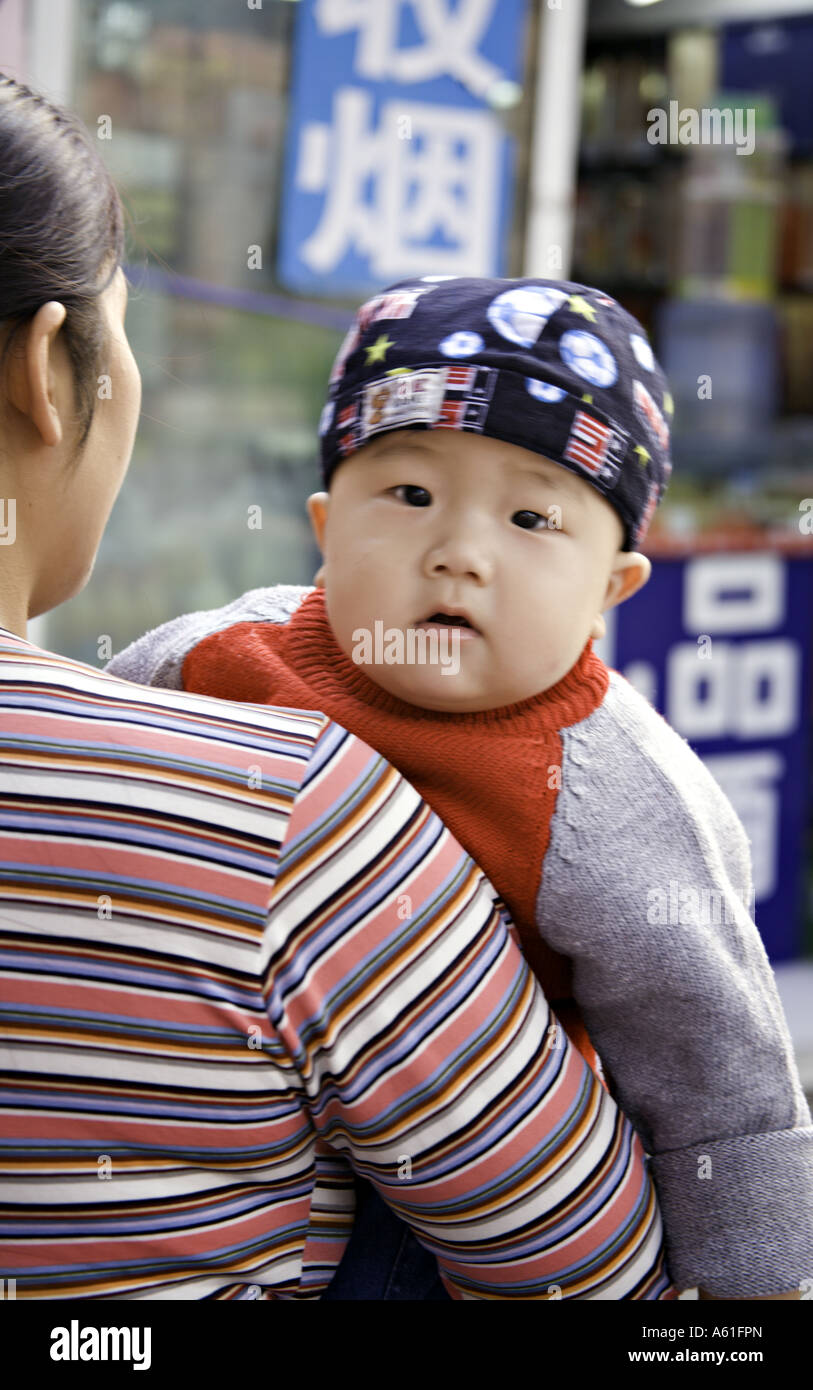 CHINA BEIJING Young Chinese mother carries her inquisitive infant son ...