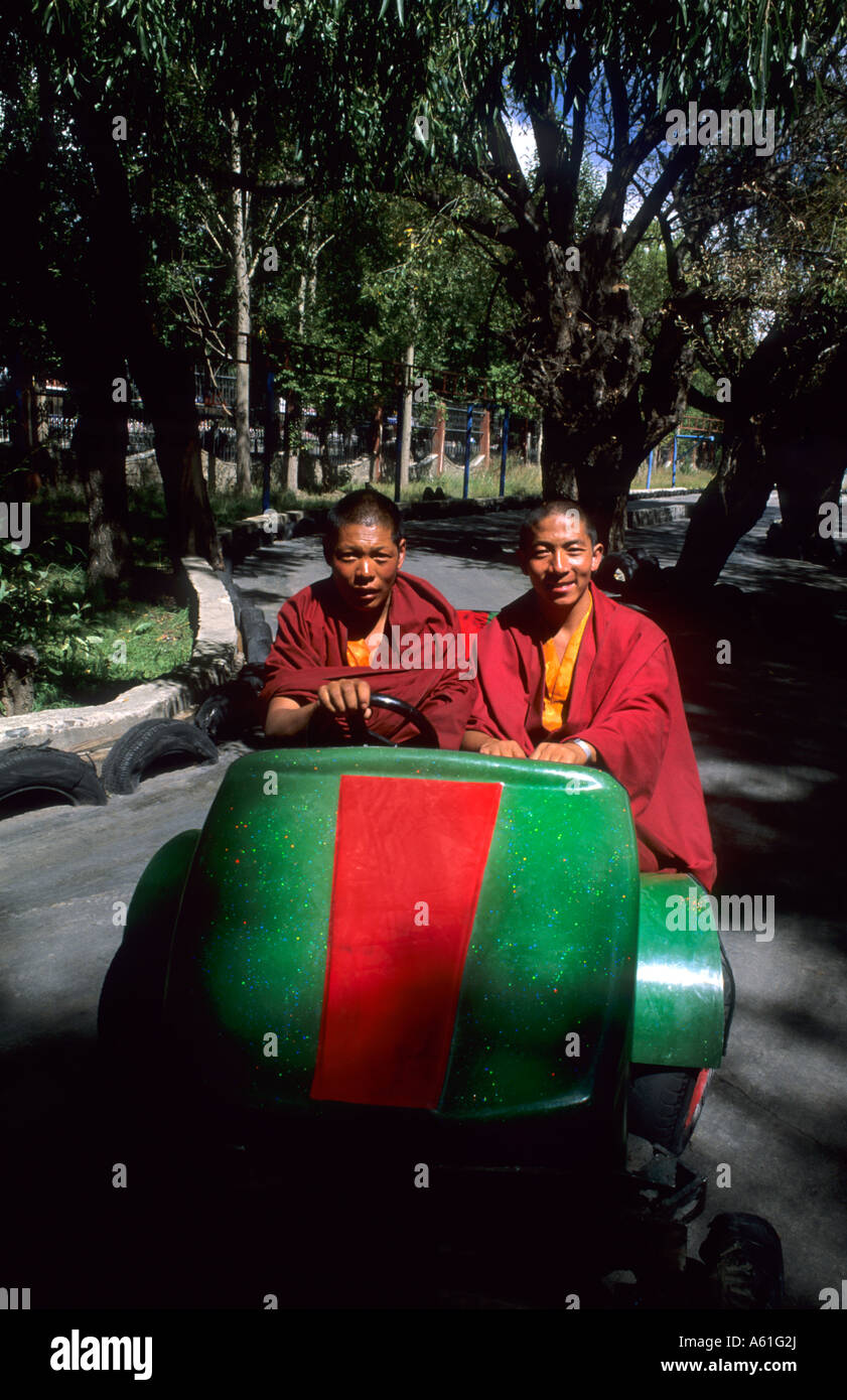 Colorful monks riding car at amusement park behind the home of the ...
