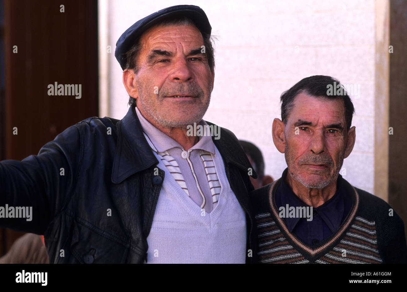 Tough and rough old fishermen relaxing at a bar in the village of Olmao ...