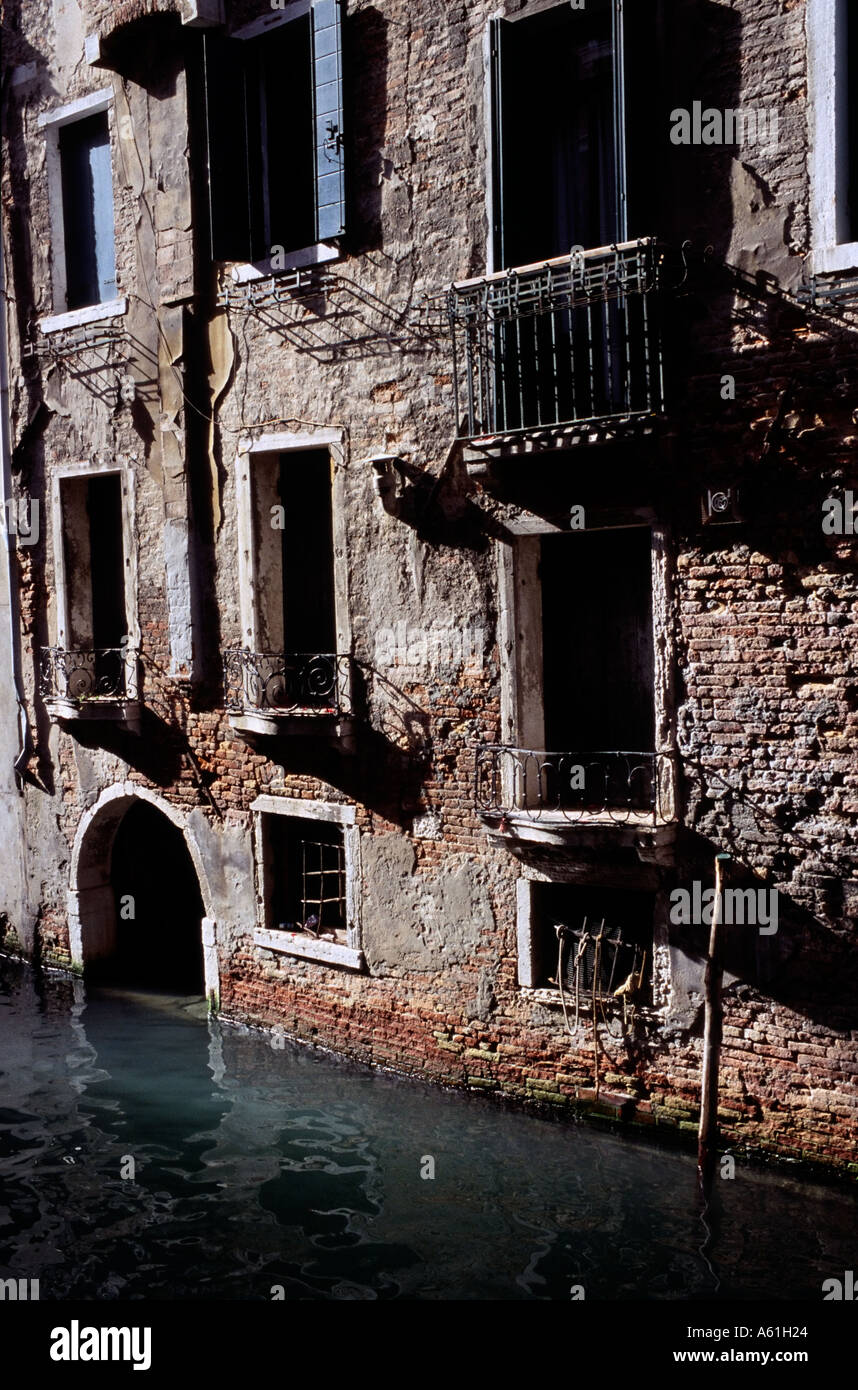 Weathered Villa fascia and exposed brick work of a canal side building ...