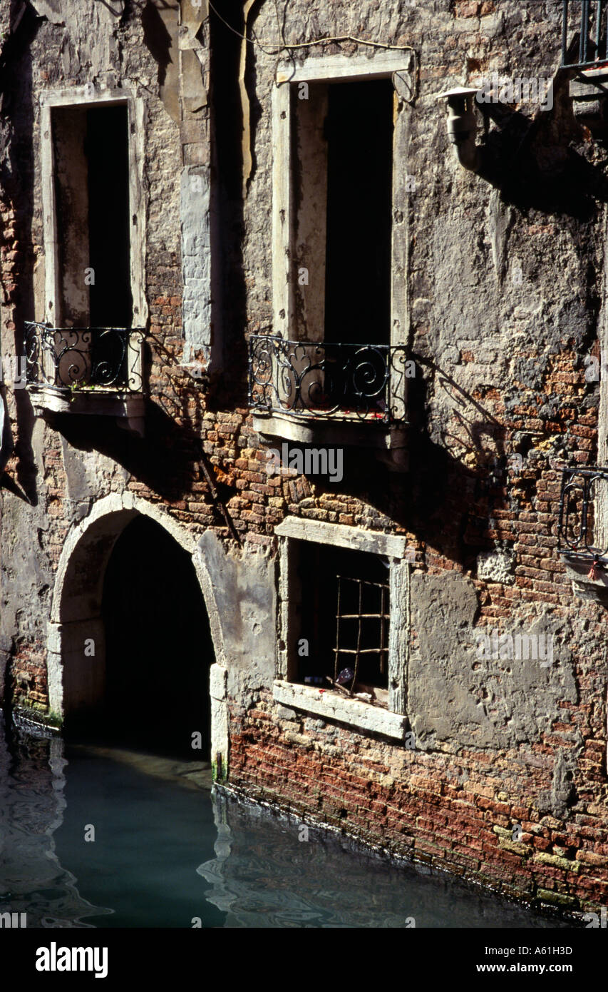 Weathered Villa fascia and exposed brick work of a canal side building ...