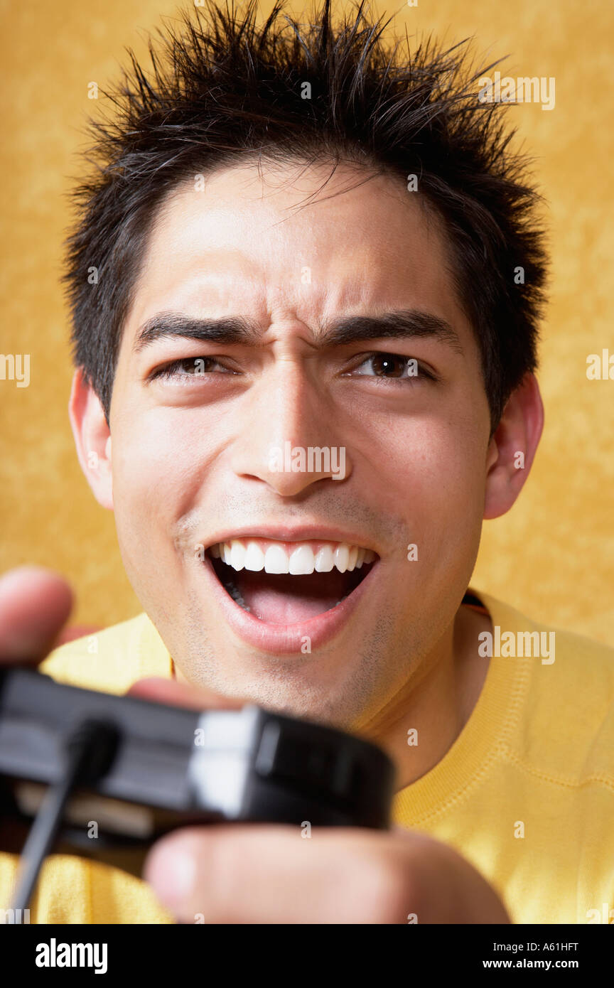 Close up Hispanic man playing video games Stock Photo - Alamy