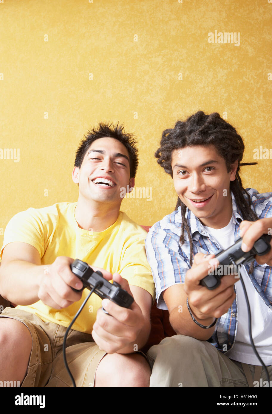 Two Hispanic men playing video games Stock Photo - Alamy