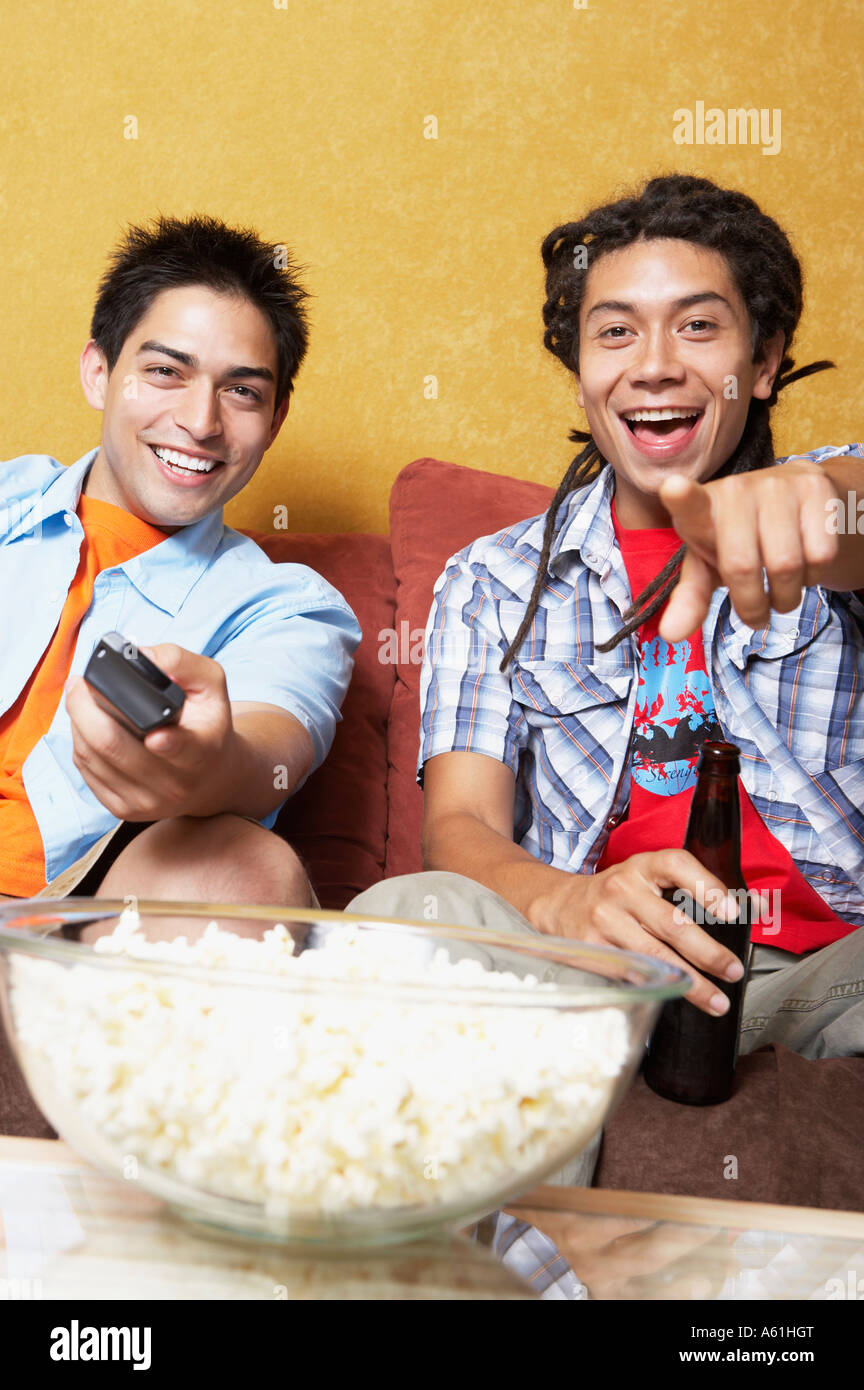 Two Hispanic men watching television Stock Photo - Alamy