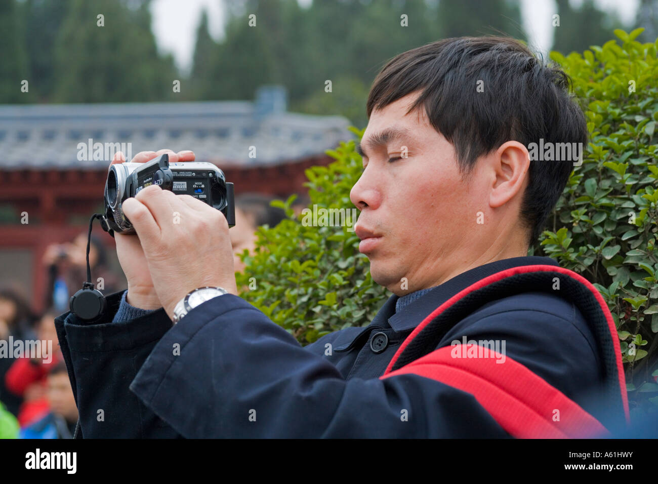 Chinese man visitor to the tomb of Emperor Qin Shihuang using small JVC ...