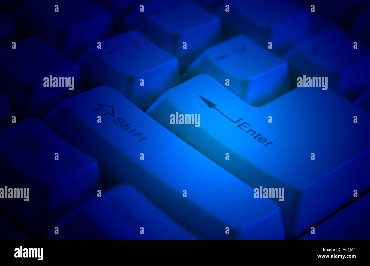 Computer keyboard lit by blue light Stock Photo - Alamy