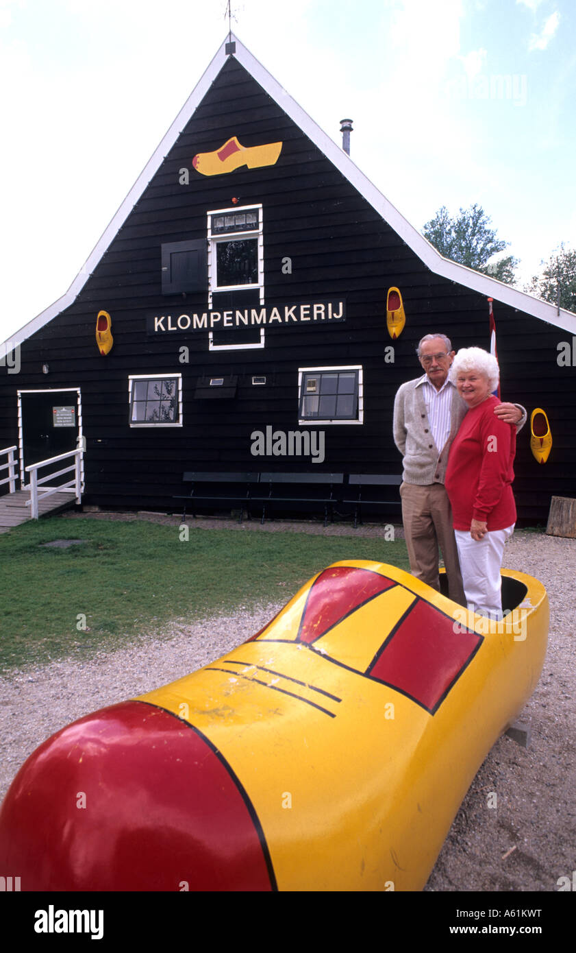 Retired couple tourists at Cheese Factory with giabt clog shoe in ...