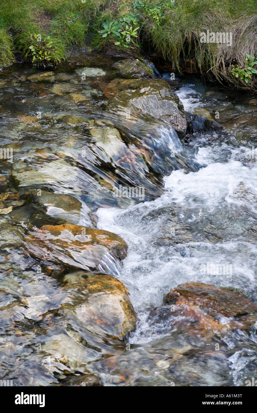 A stream rushing over rocks Stock Photo - Alamy