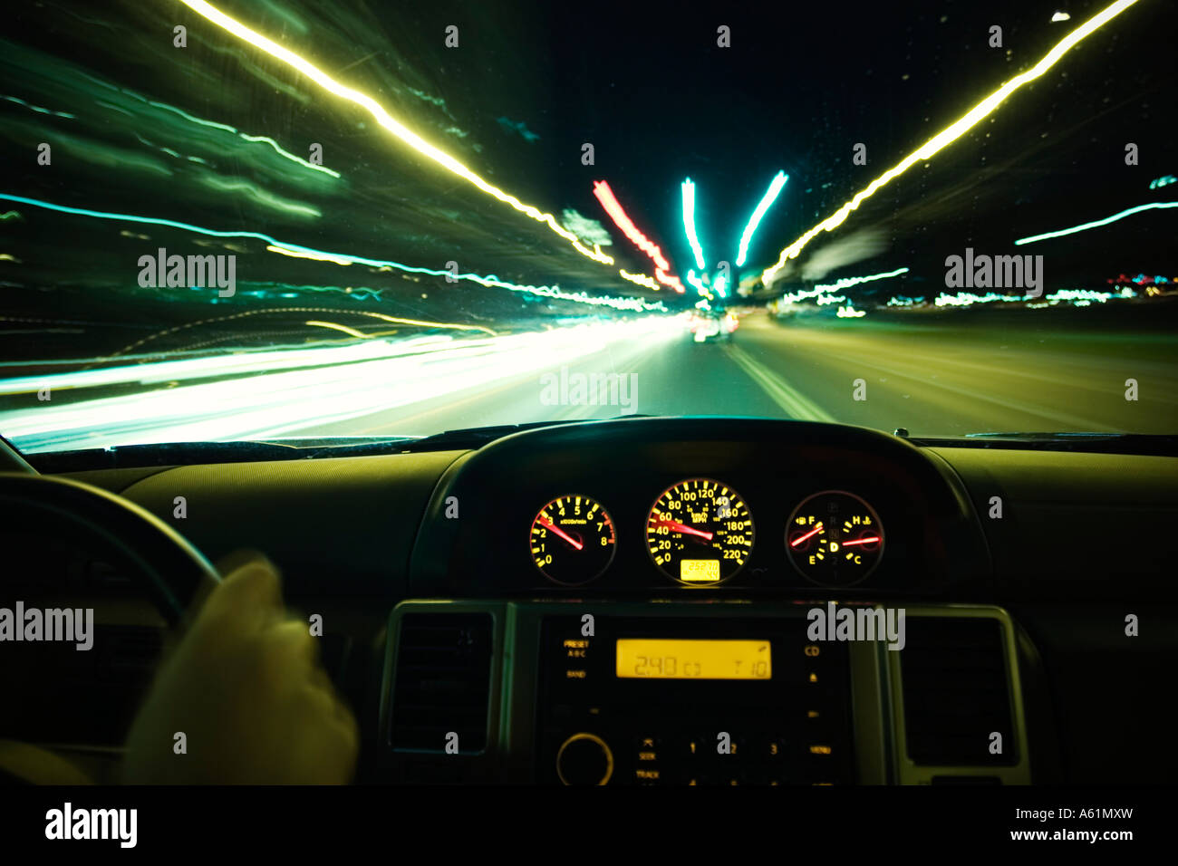 driving a car by night with light trails seen from the passenger ...