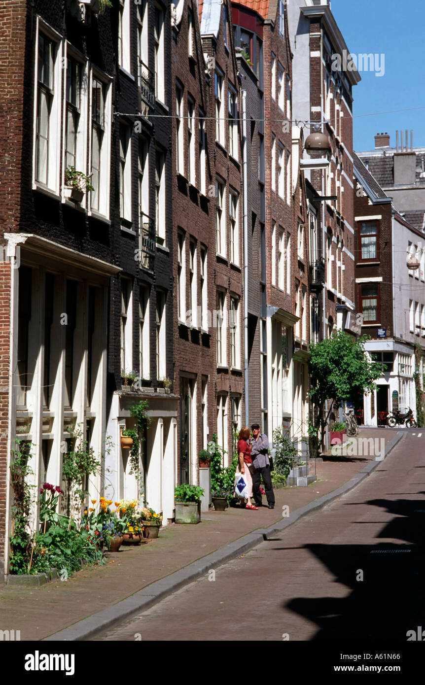 Dutch man and woman talking in Amsterdam street Stock Photo - Alamy
