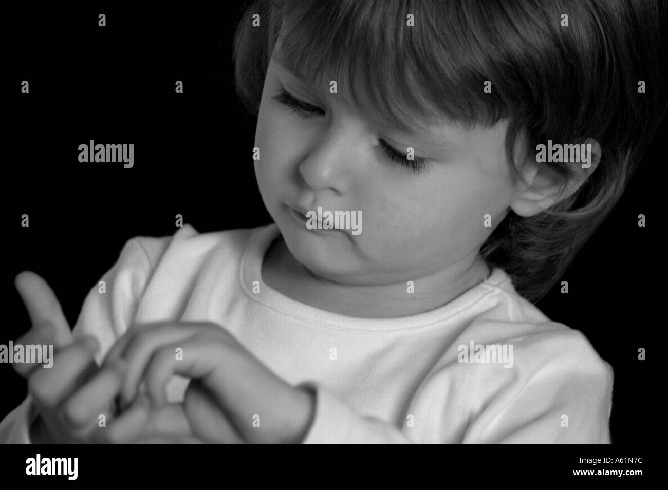 Toddler counting fingers portrait Stock Photo - Alamy