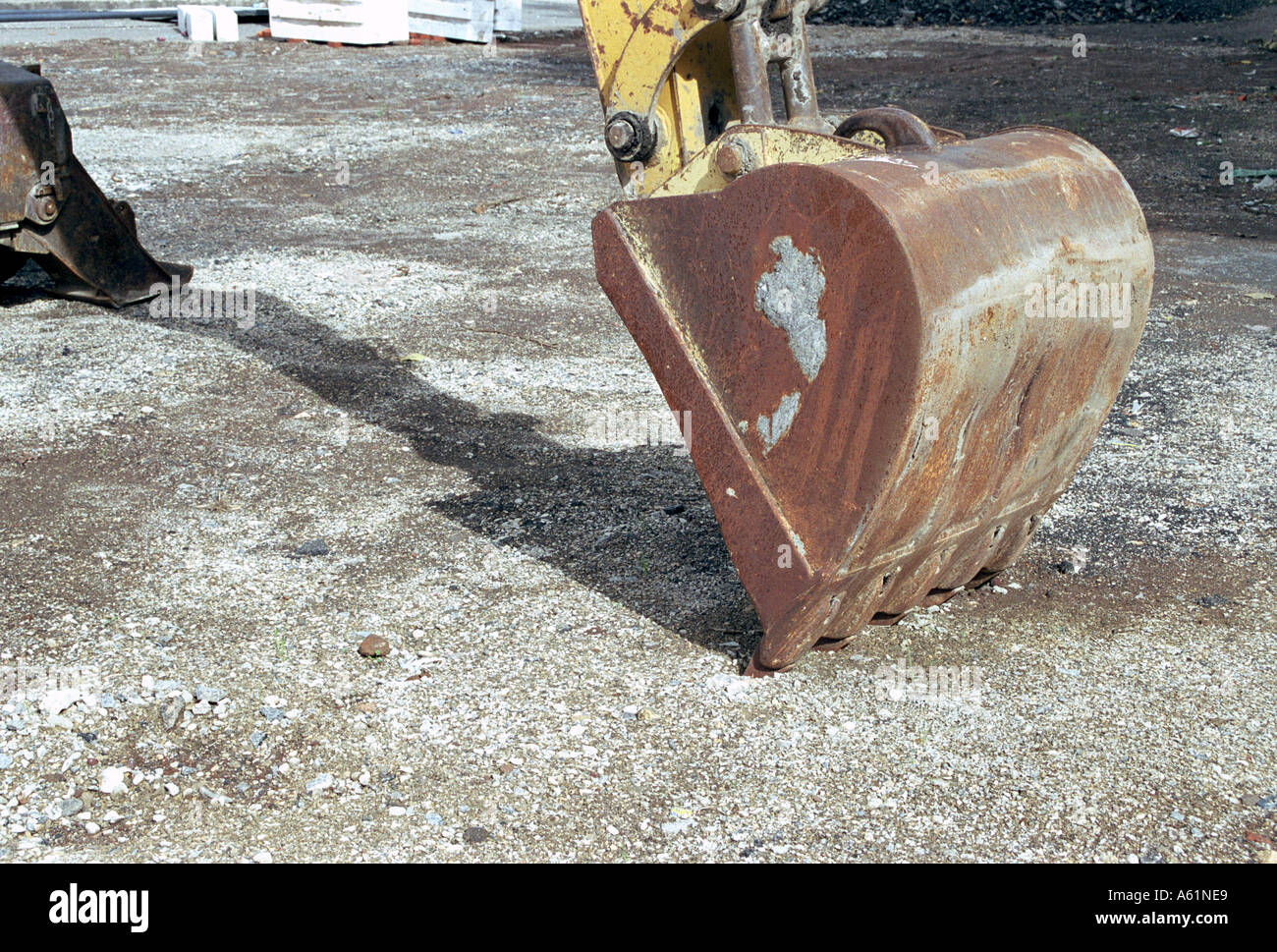 excavator digging into ground on building site Stock Photo - Alamy