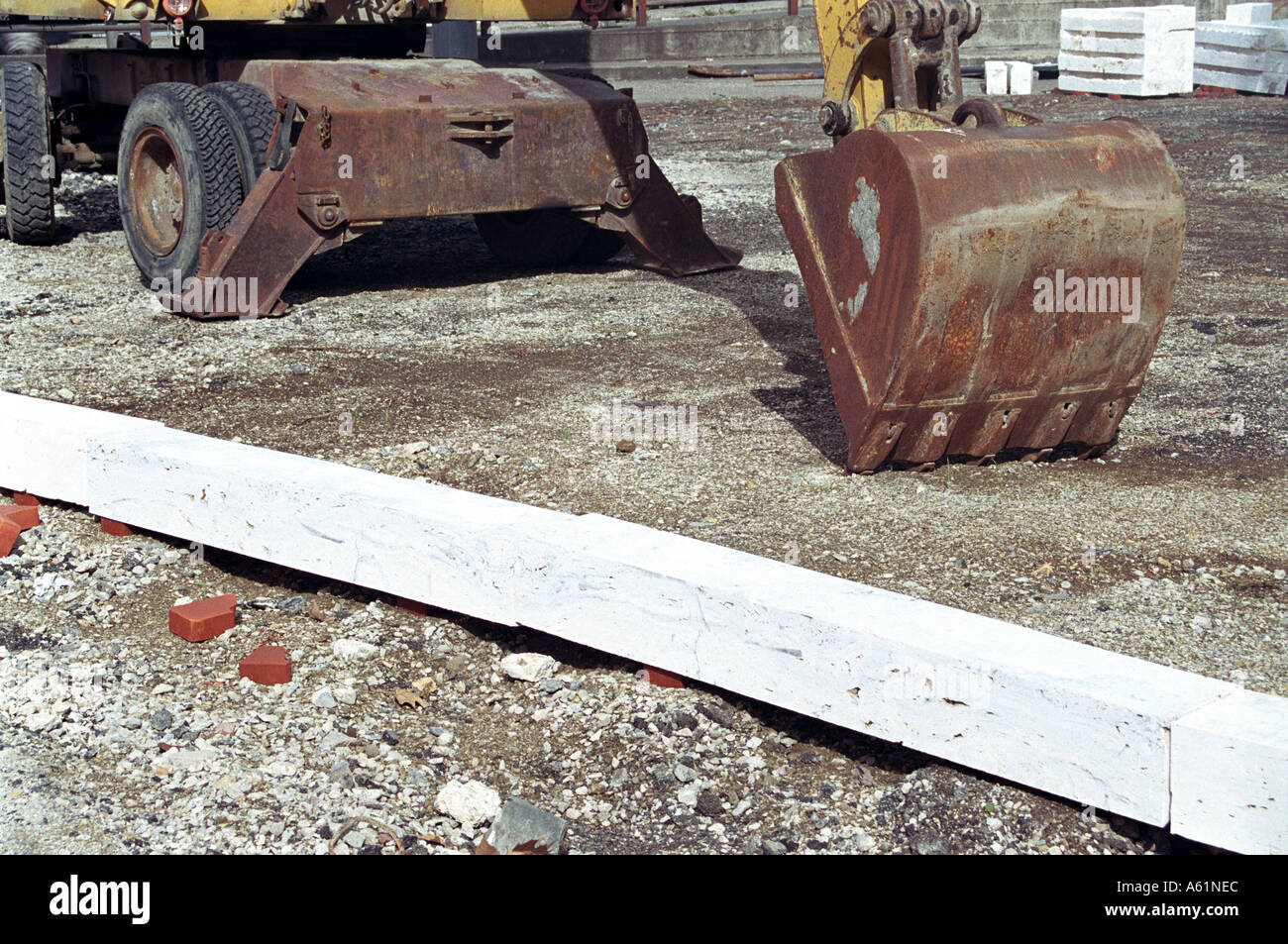 excavator digging into ground on building site Stock Photo - Alamy