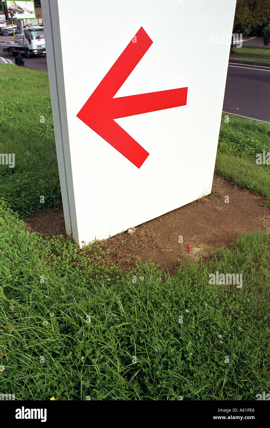 red arrow direction sign on grass Stock Photo - Alamy