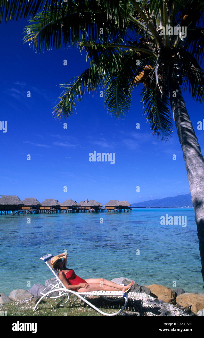 Beautiful woman relaxing by ocean in beautiful Tahiti in French ...