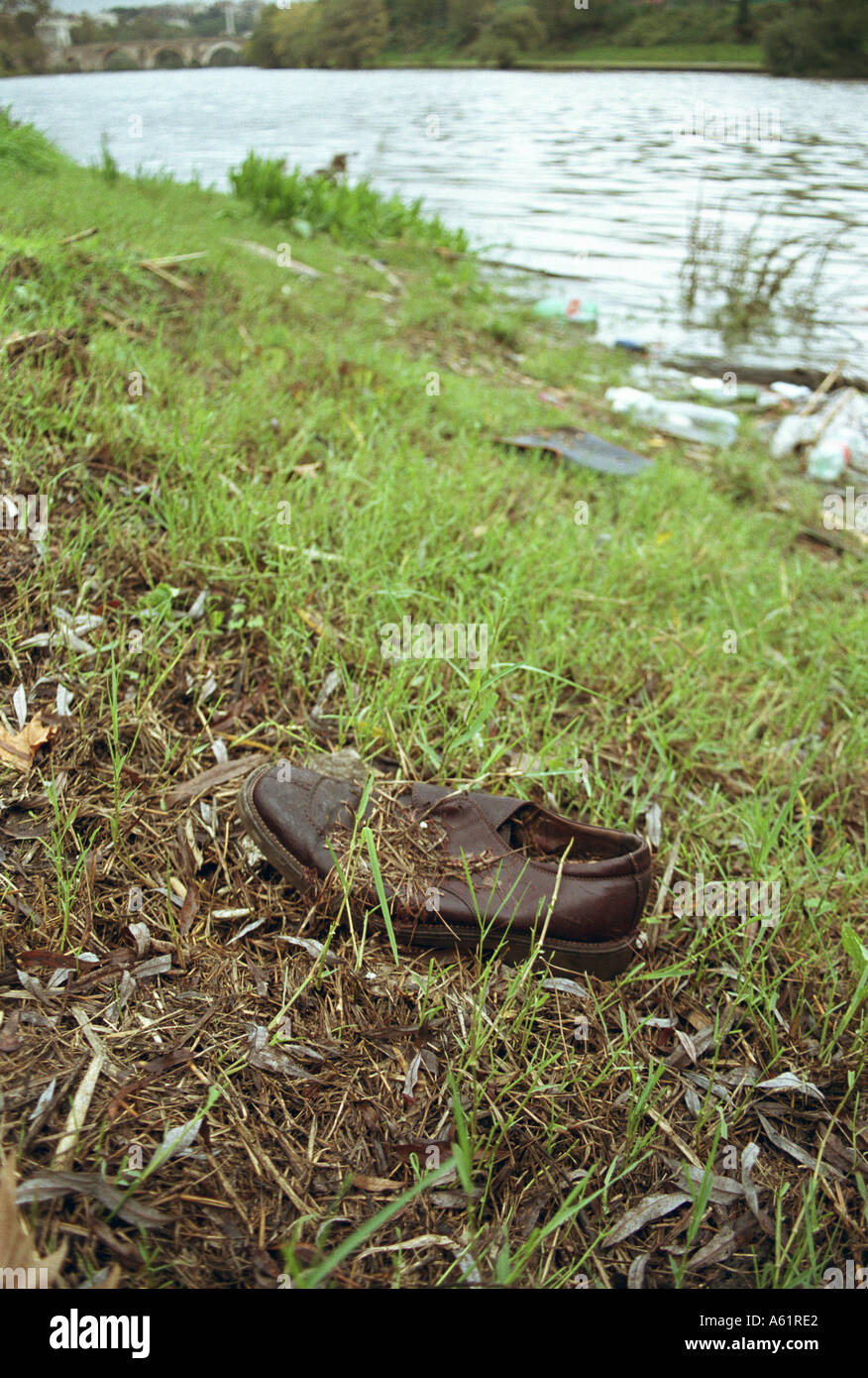 old shoe washed up on river back Stock Photo - Alamy