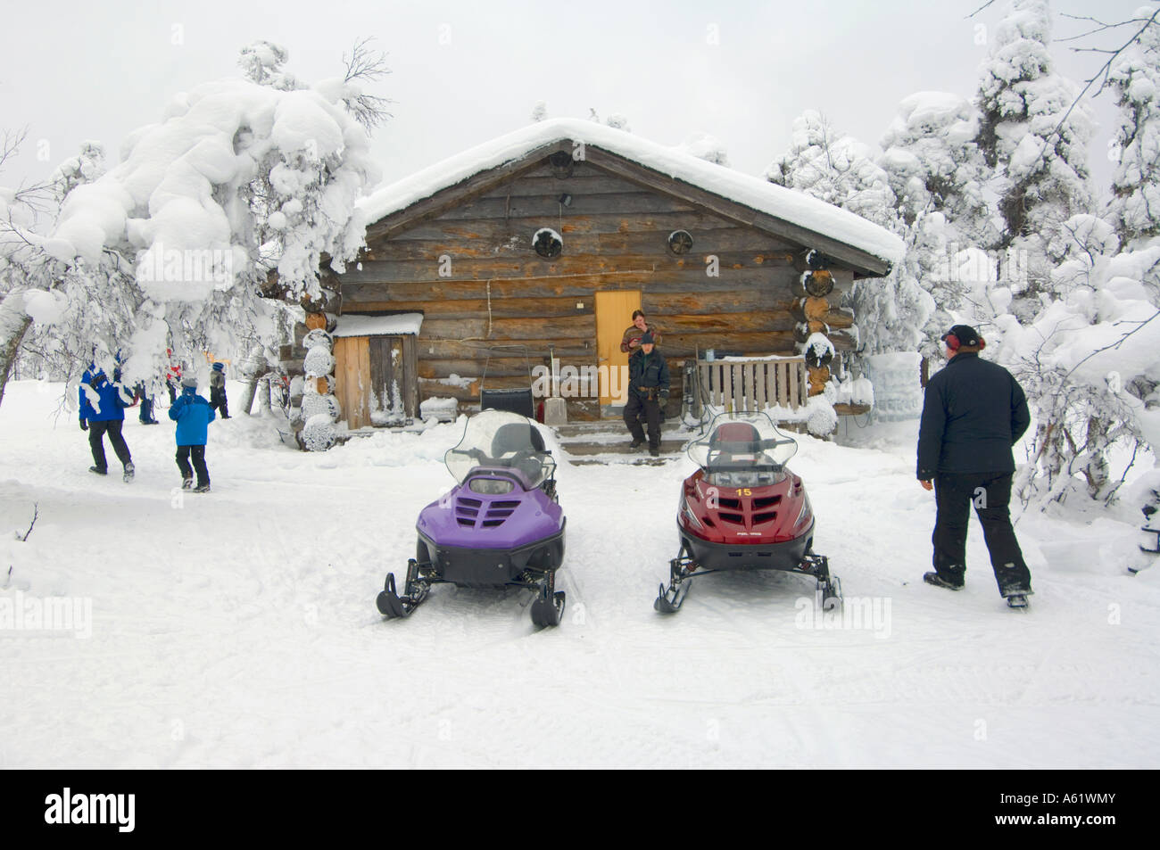 Log cabin with snowmobiles in the snow, Luosto, Lapland, Northern ...