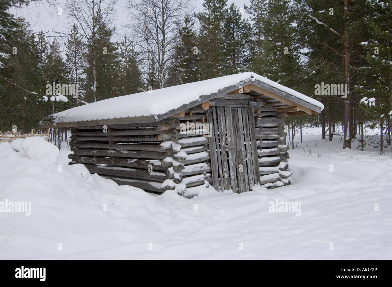 Typical Finnish log cabin in the forest in the snow Luosto, Lapland ...
