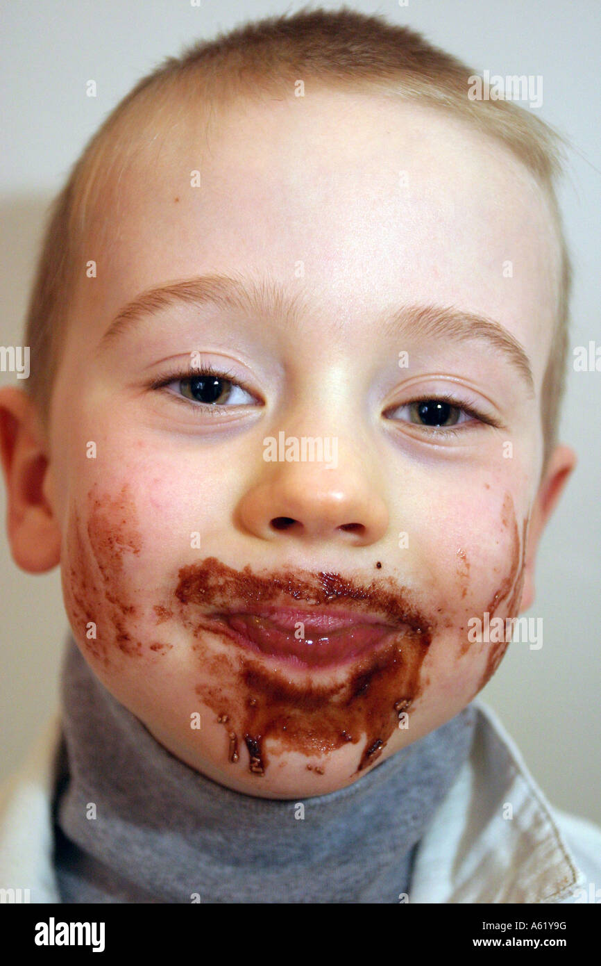 Valentines day. young boy with chocolate smeared all over face Stock ...