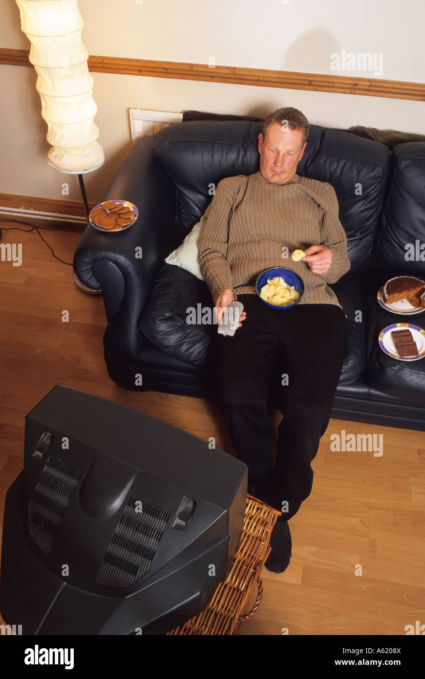 Fat man watching tv in sofa hi-res stock photography and images - Alamy