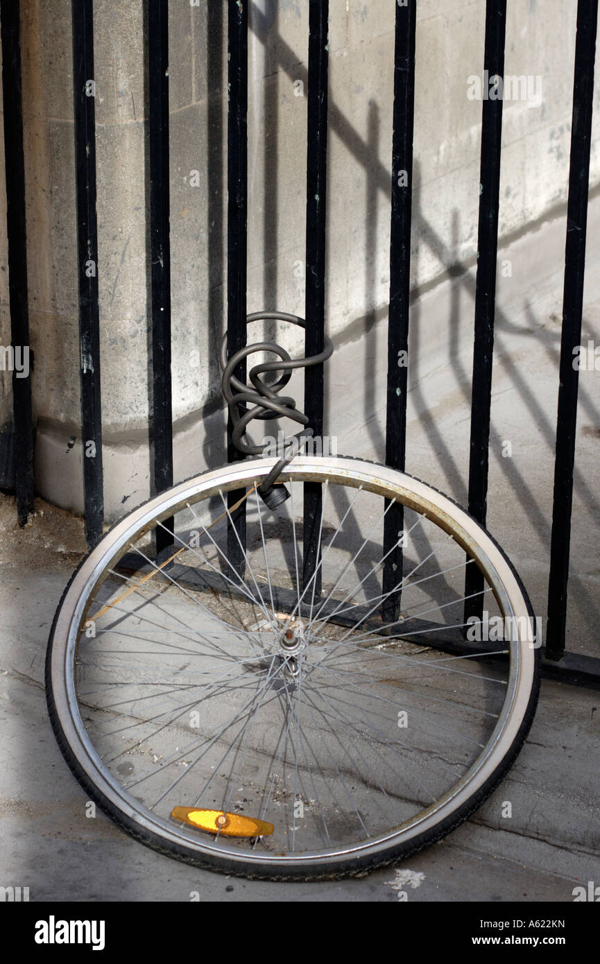 Abandoned bicycle wheel chained to railings Stock Photo - Alamy Abandoned bicycle wheel chained to railings Stock Photo - Alamy