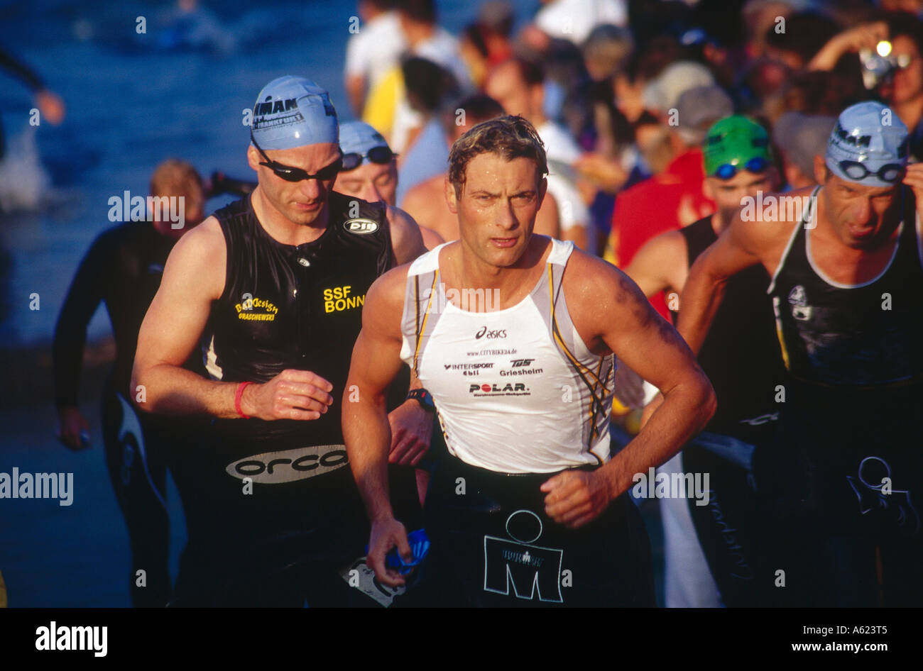 Group of men running in a triathlon event Stock Photo - Alamy
