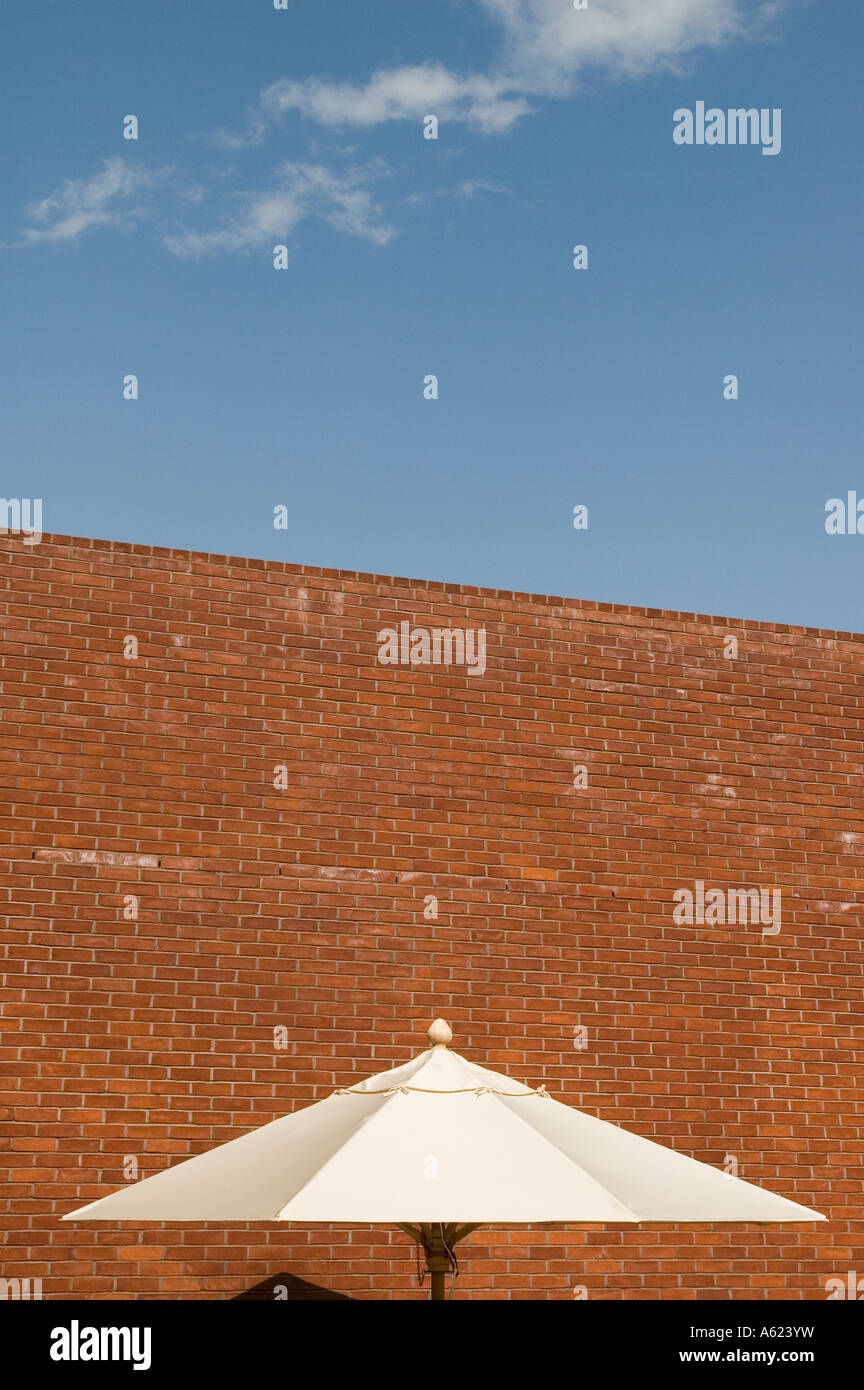 patio umbrella outside with brick wall and sky Stock Photo - Alamy