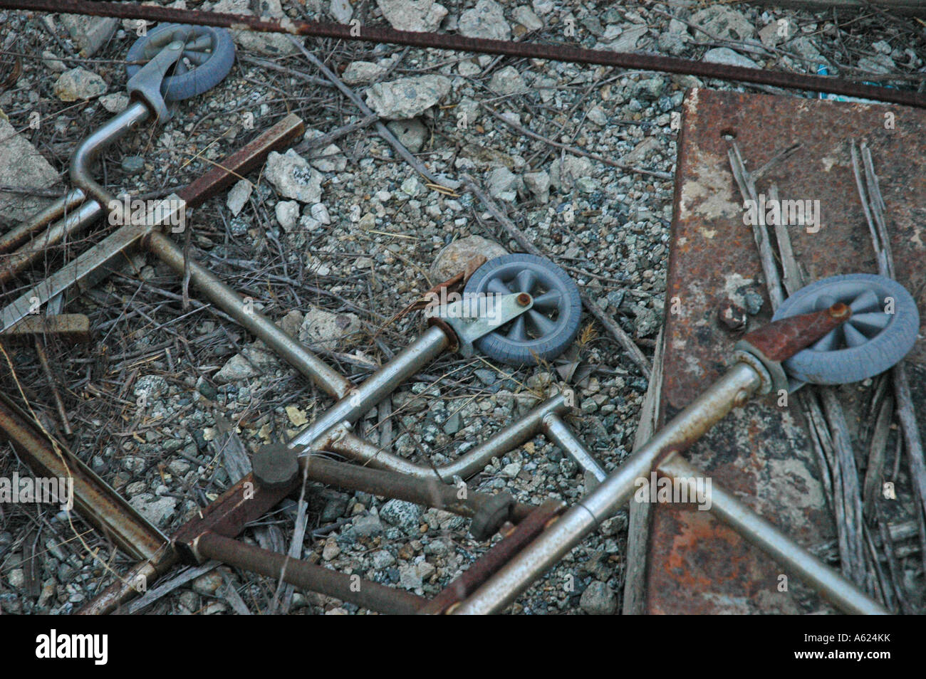 Abandoned walker rusting amongst other debri Stock Photo - Alamy