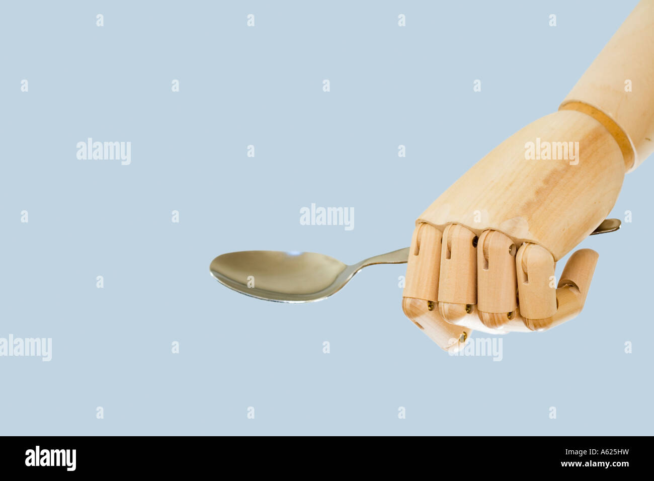 Wooden hand holding spoon Stock Photo - Alamy