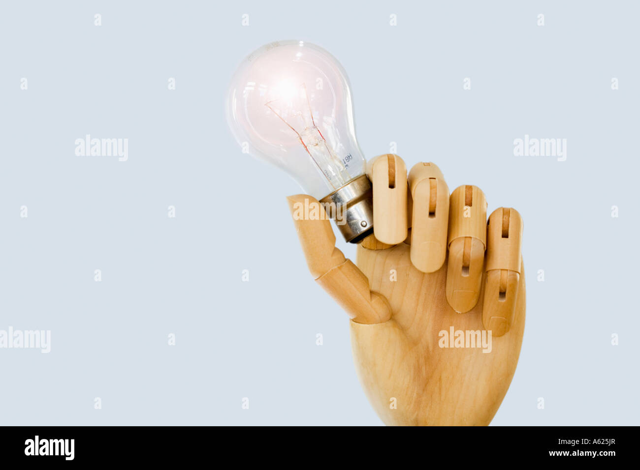 Wooden hand holding lit electric light bulb switch on Stock Photo - Alamy