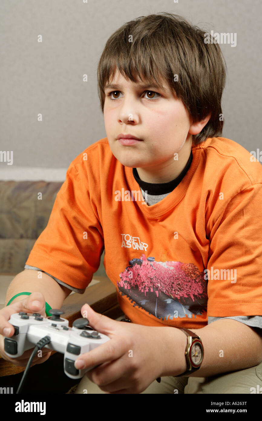 portrait of a young boy playing playstation Stock Photo - Alamy