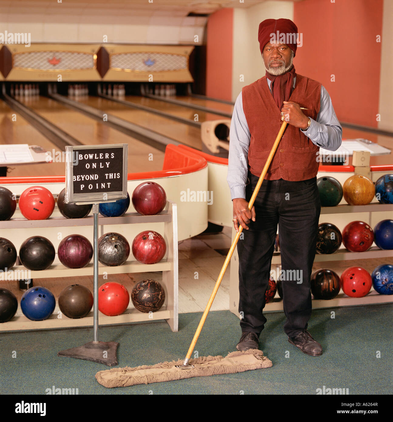 Man Sweeping at Bowling Alley Stock Photo - Alamy