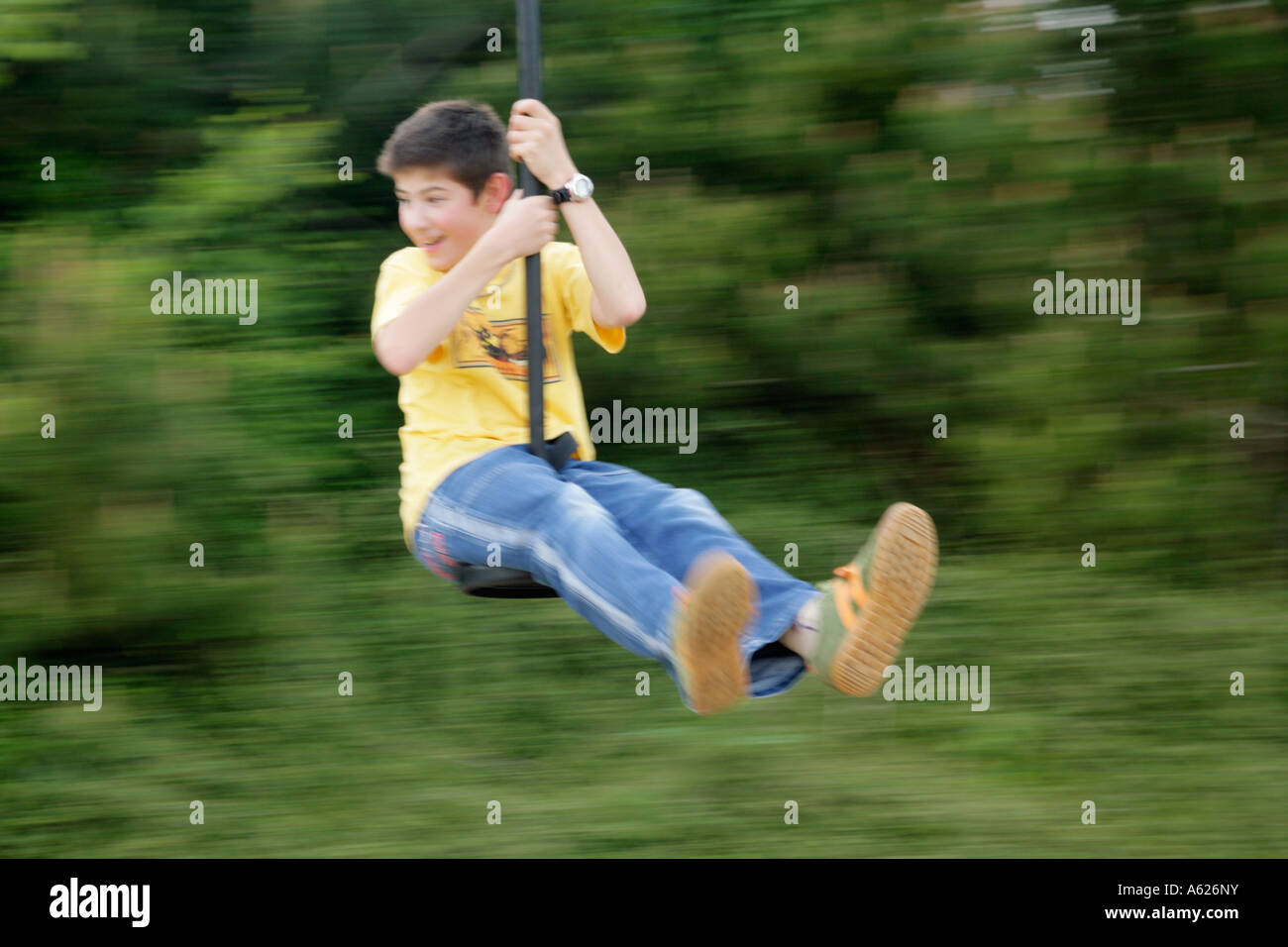 a young boy riding a toy ropeway Stock Photo - Alamy