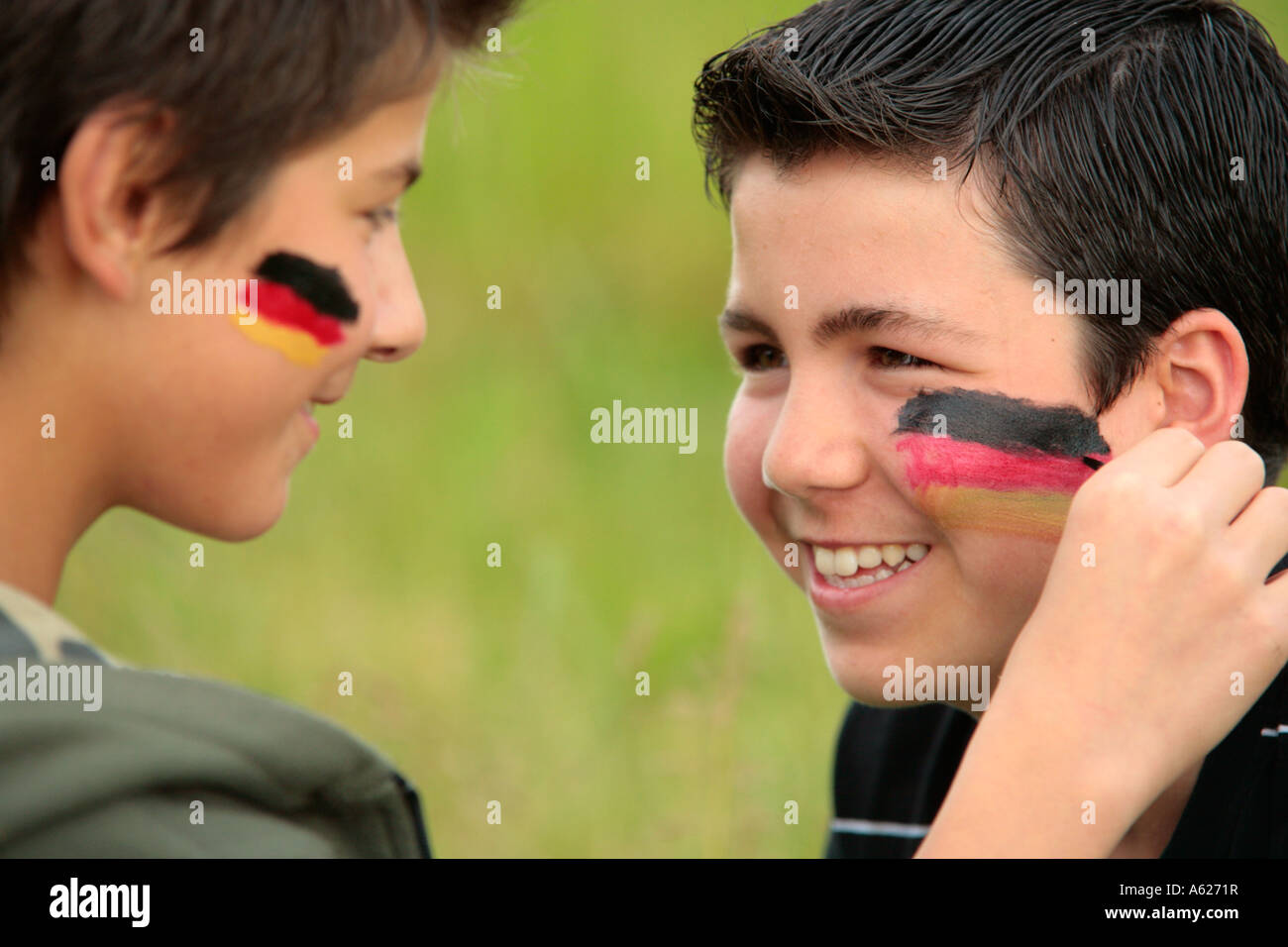 two young boys drawing German flags onto each other´s cheeks Stock ...