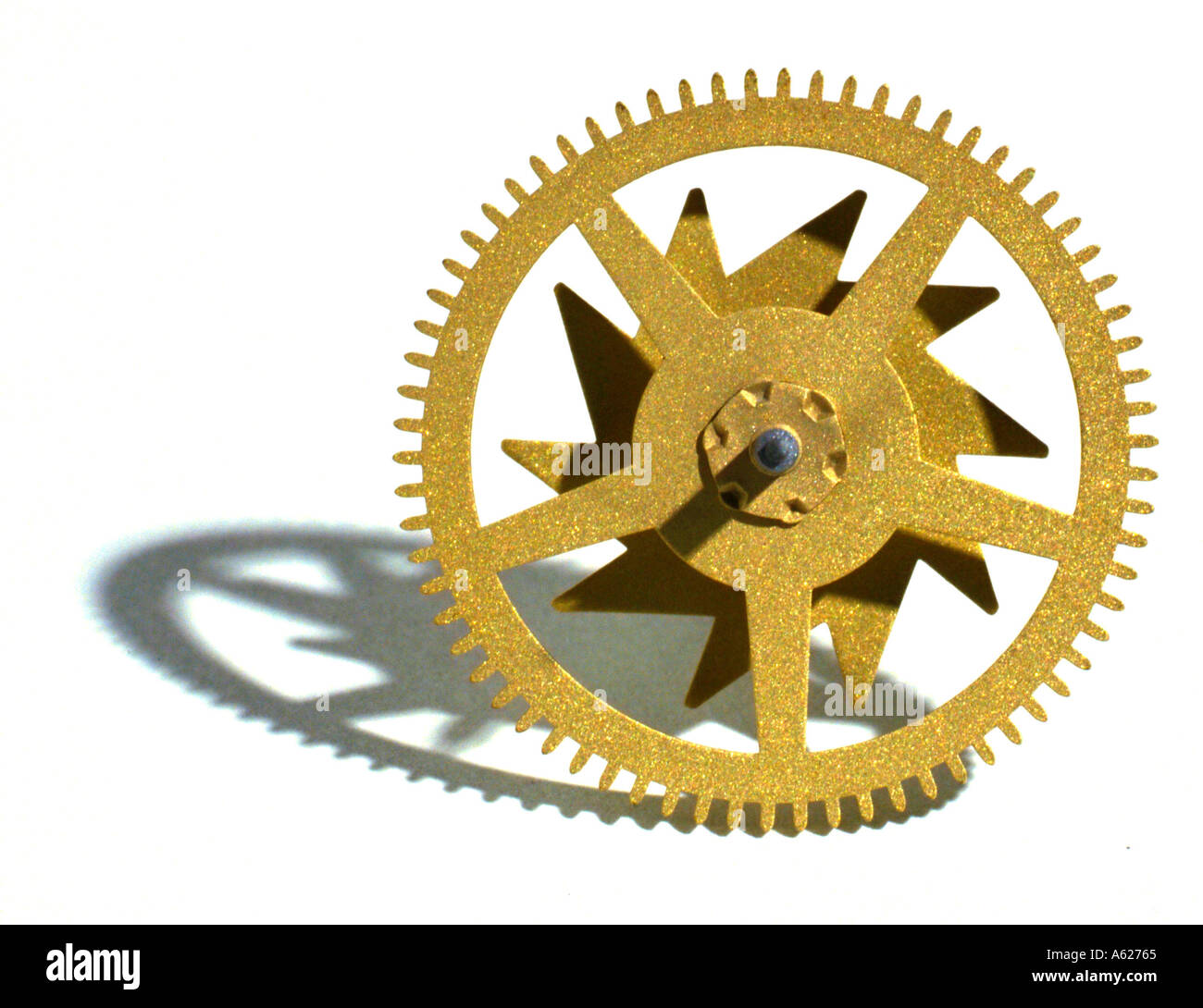Gold gear from clock Stock Photo - Alamy