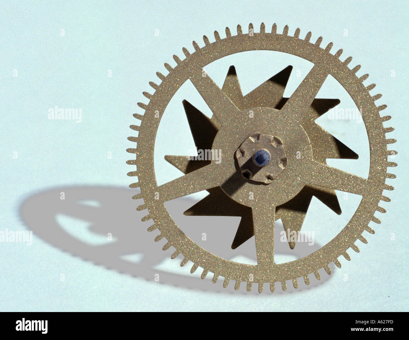 Single gold gear with shadow Stock Photo - Alamy