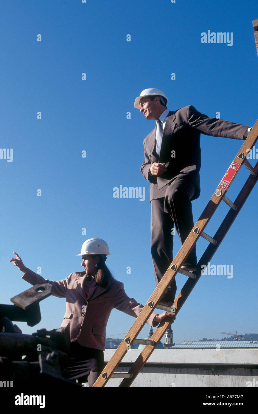 Male and female architects at building site Stock Photo - Alamy