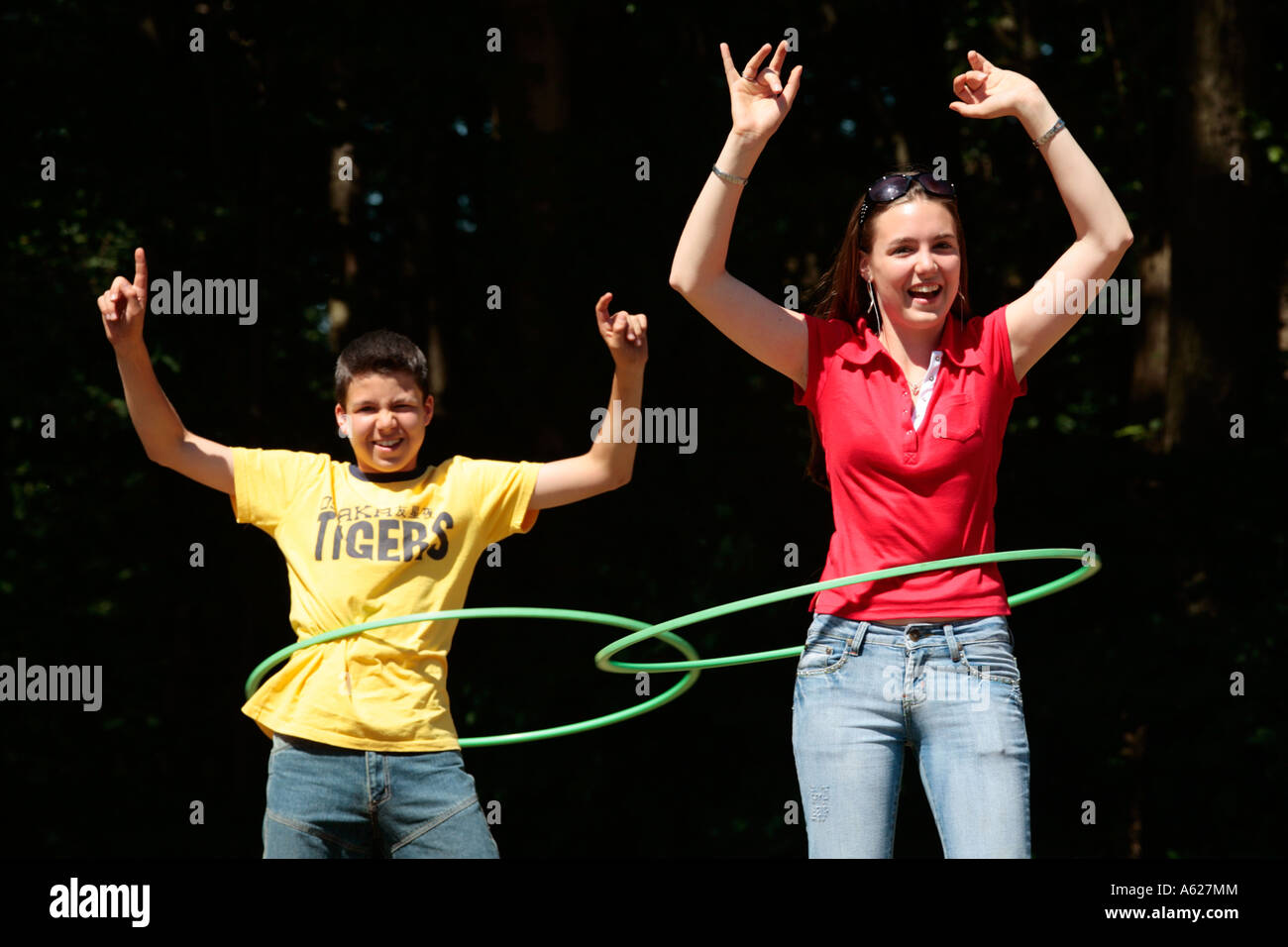 two teenagers with hula hoop tyres Stock Photo - Alamy