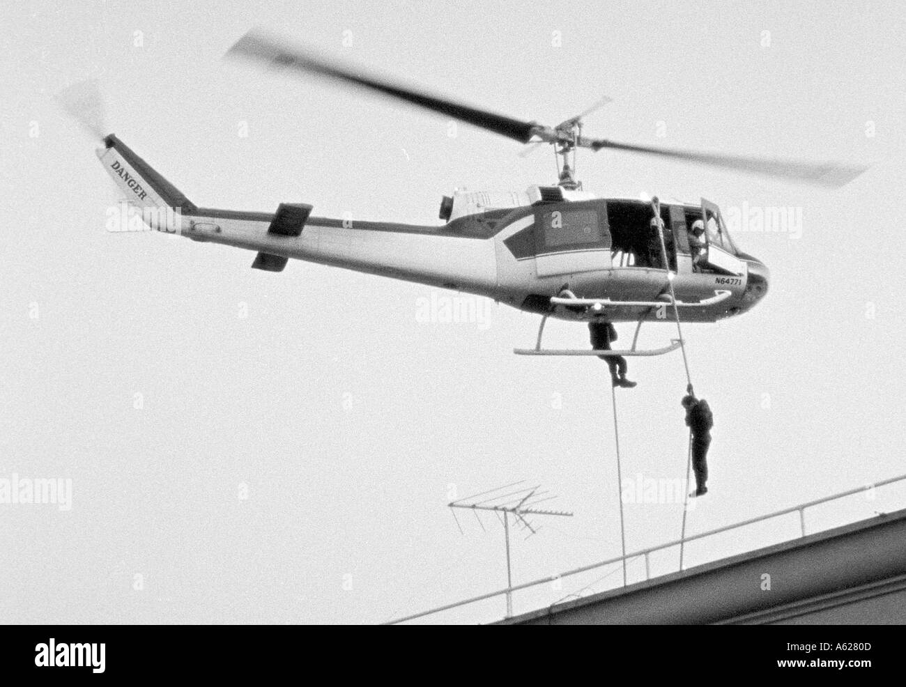 Men drop from helicopter during security operation Stock Photo - Alamy