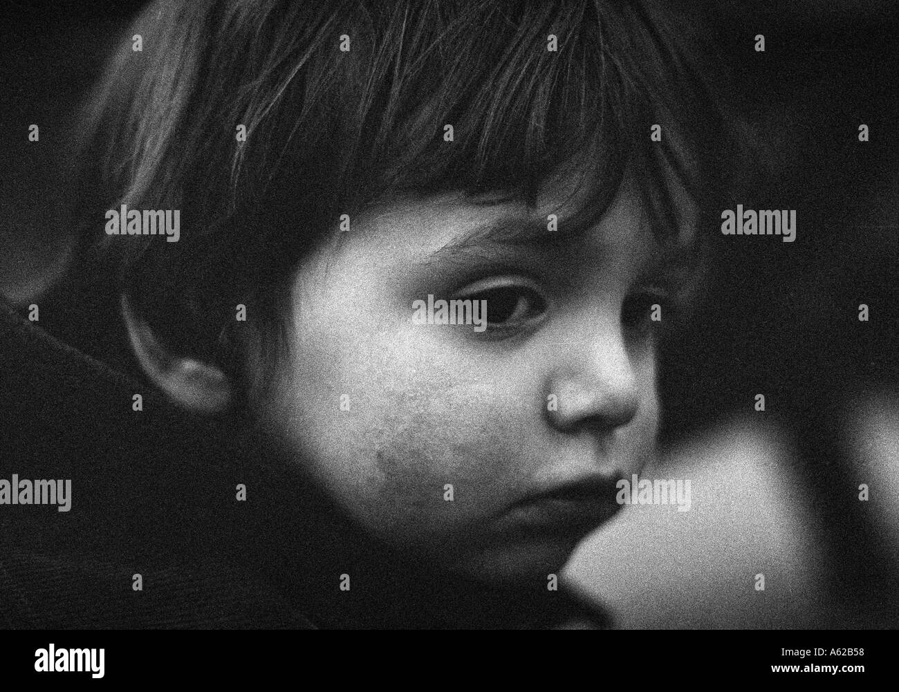 gritty head shot of small boy looking sad and downcast Stock Photo - Alamy