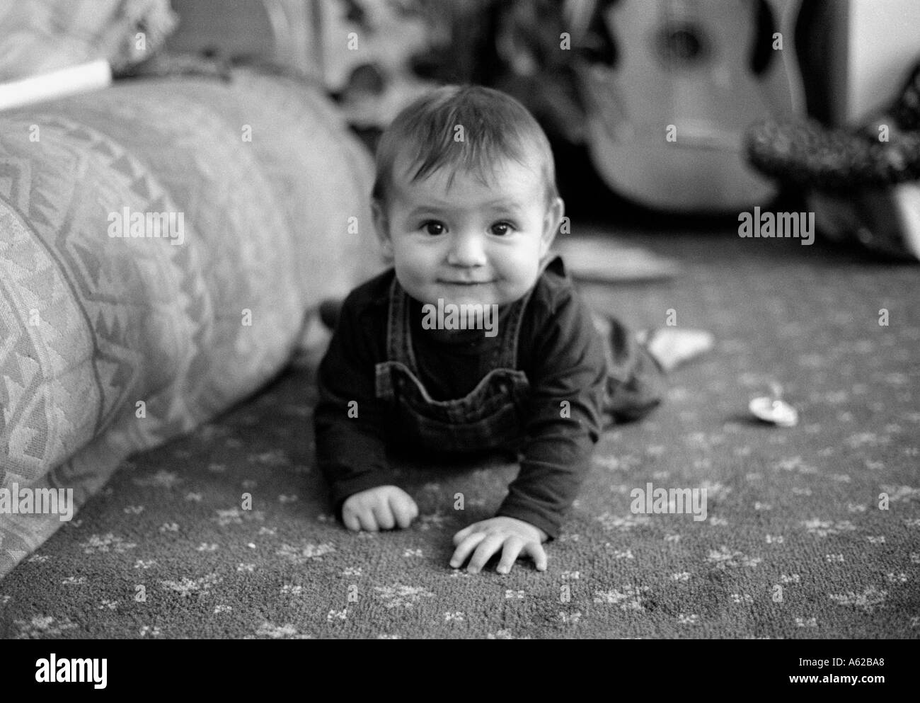 baby boy crawling on carpet towards camera smiling Stock Photo - Alamy